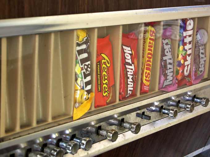 Candy dreams line up behind glass&mdash;M&Ms, Reese's, and Hot Tamales waiting patiently to complete your meal with a sweet finale.