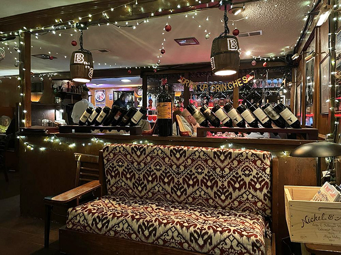 The waiting area's pattern-rich couch and ambient bar lighting whisper, "Stay awhile." Wine bottles stand at attention like delicious soldiers.