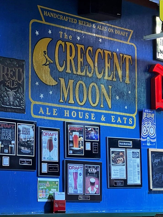The blue wall proudly displays the Crescent Moon name amid a constellation of beer accolades. A shrine to craft brewing excellence.