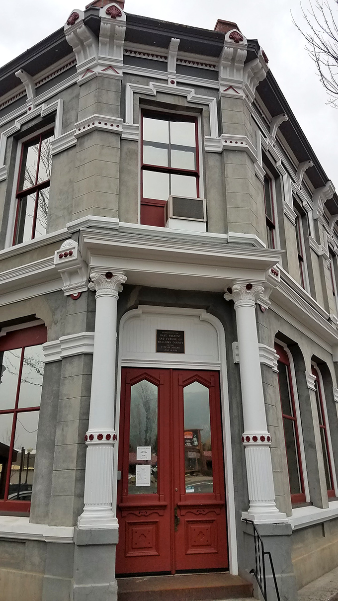 The Wallowa County Museum's ornate Victorian architecture stands as proof that even frontier towns appreciated a good cornice and red doorway.