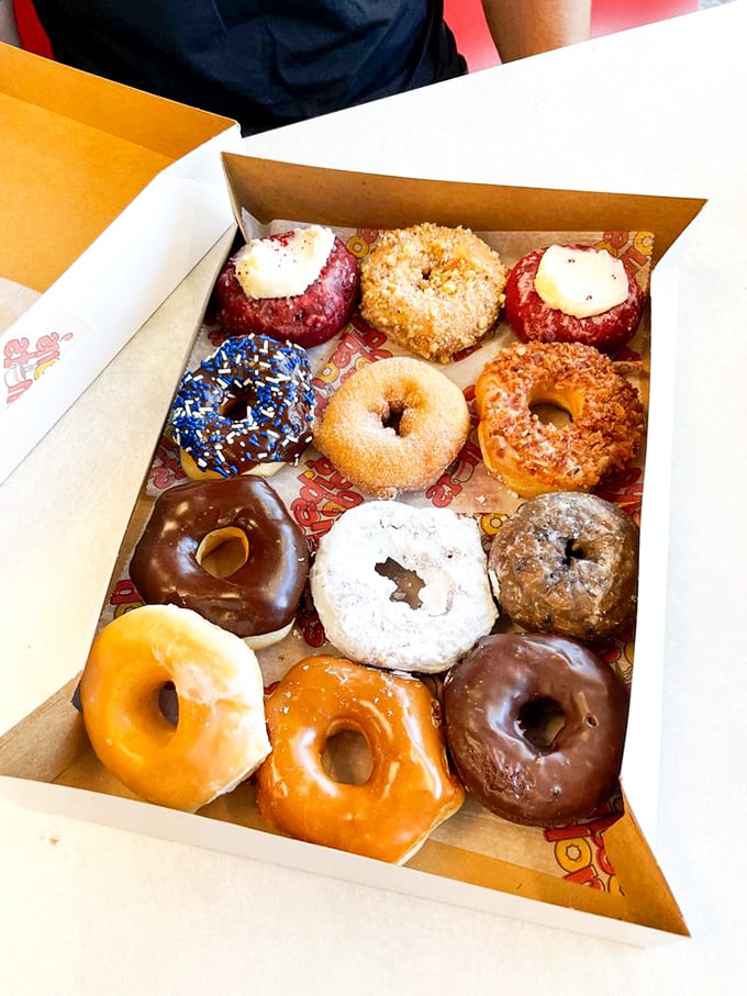 This isn't just a box of donuts; it's a color wheel of happiness with each perfectly placed pastry promising its own distinct joy.