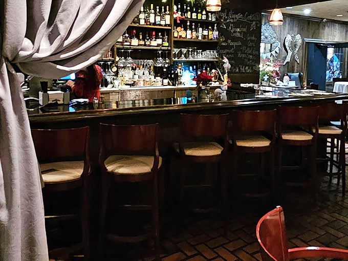 The bar at Wooden Angel&mdash;where bottles stand like sentinels guarding liquid happiness and barstools invite you to stay awhile.