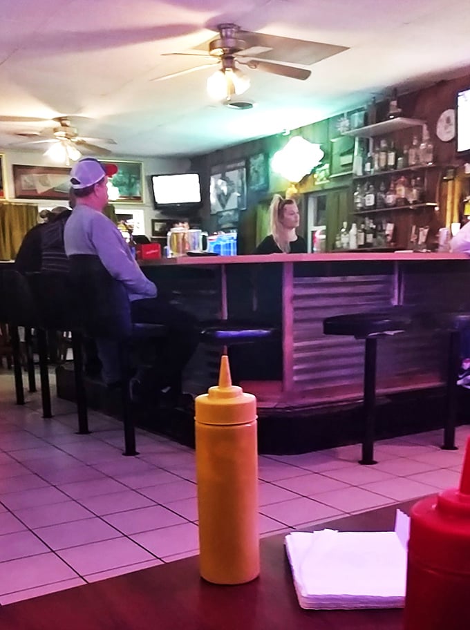 The bar where everybody might not know your name yet, but they'll remember your order. Yellow mustard bottle standing guard like a sentinel.