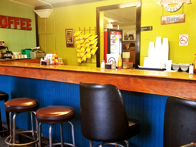 Bar seating: where solo diners become regulars and regulars become family. The blue wainscoting adds just enough charm.