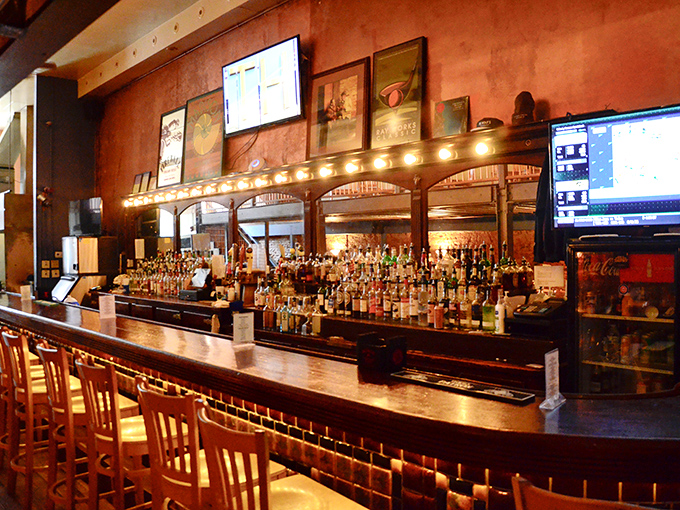 The bar gleams with bottles like a liquid library, each one promising to enhance your seafood adventure in its own special way.