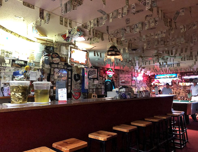 The bar at Guy & Mae's serves cold drinks with warm conversation. Where locals and pilgrims alike gather to debate important matters like sauce versus dry rub.