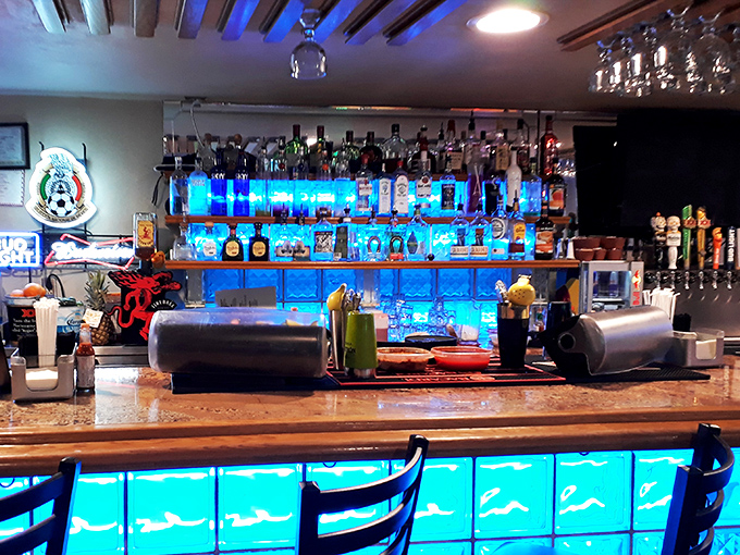 The blue-lit bar glows like an underwater grotto. Those bottles aren't just spirits&mdash;they're liquid courage for seafood adventures.