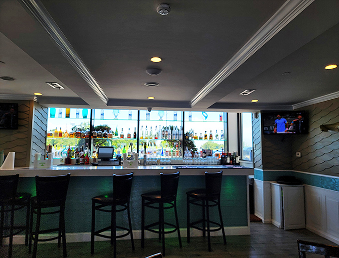 A bar that understands the sacred relationship between cold drinks and hot days, illuminated like an aquatic wonderland.