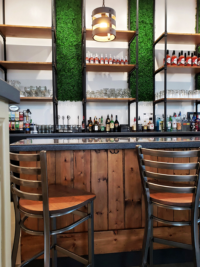 Not just a bar, but a shrine to brunch libations. Those wooden panels and green accents create the perfect stage for morning cocktail magic.
