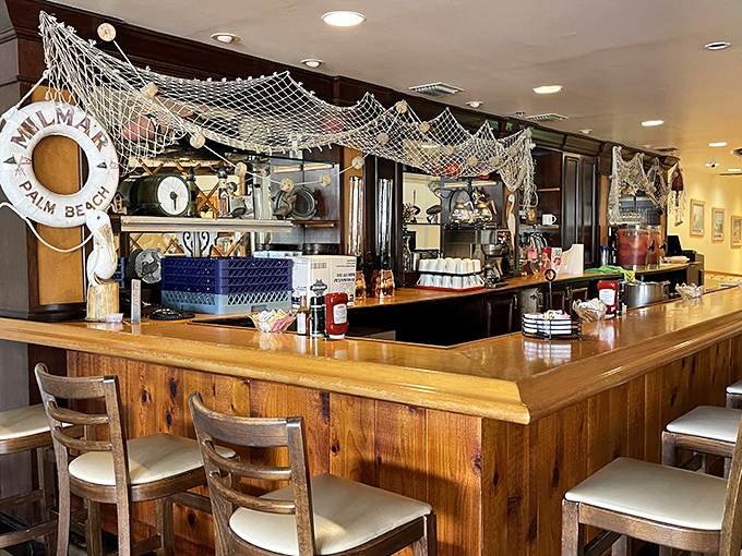 The nautical-themed bar whispers tales of the restaurant's beachfront past. Those life preservers aren't just decoration—they're memories of Lake Worth Beach.