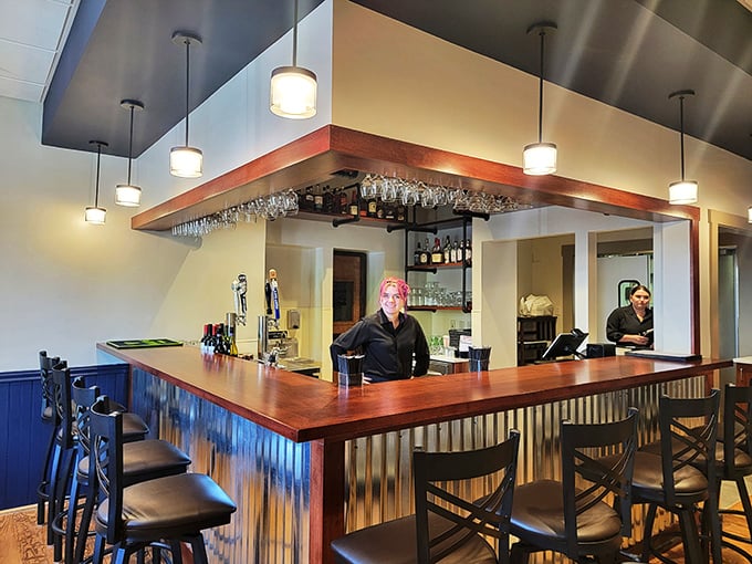 A bar that understands its purpose: to provide liquid courage before you order that second dessert. The warm wood tones practically whisper, "Go ahead, you deserve it."