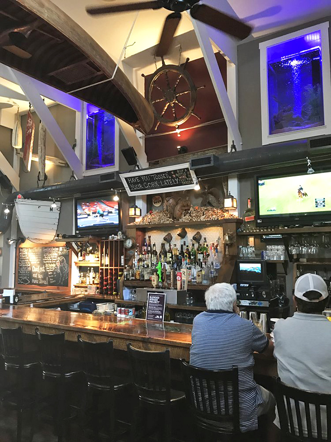 A ship's wheel watches over bottles that stand at attention. This isn't just a bar&mdash;it's a captain's quarters where libations await orders.