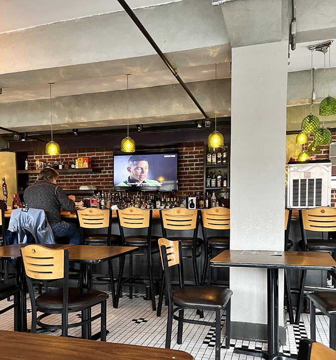 A bar backed by bottles of possibility, where tequila dreams and mezcal memories are crafted daily. The green pendant lights add just the right touch of fiesta.