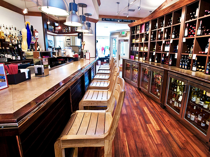 The bar gleams with promise, its wooden stools awaiting the weary traveler. Wine bottles stand at attention, ready for your selection.