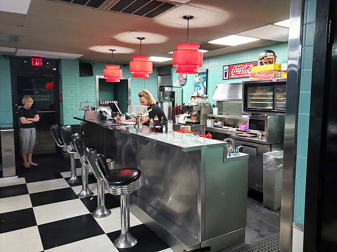 The stainless steel counter with classic soda fountain stools is where solo diners find community and the best local gossip is exchanged like currency.