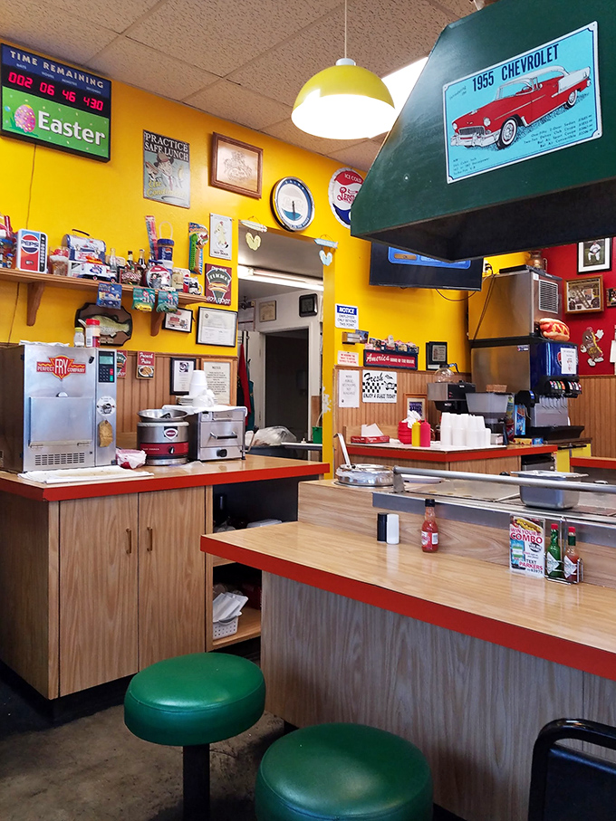 The counter where hot dog magic happens. Yellow pendant lights cast a glow that makes everything look like it belongs in a food magazine.