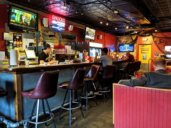 The bar at Shucks offers front-row seats to the action, where regulars exchange stories while waiting for their maritime feasts to arrive.