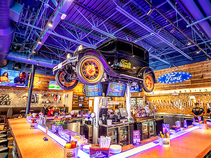A vintage Ford hangs suspended above the bar like automotive artwork. The tap handles stand ready to dispense liquid happiness to thirsty patrons below.