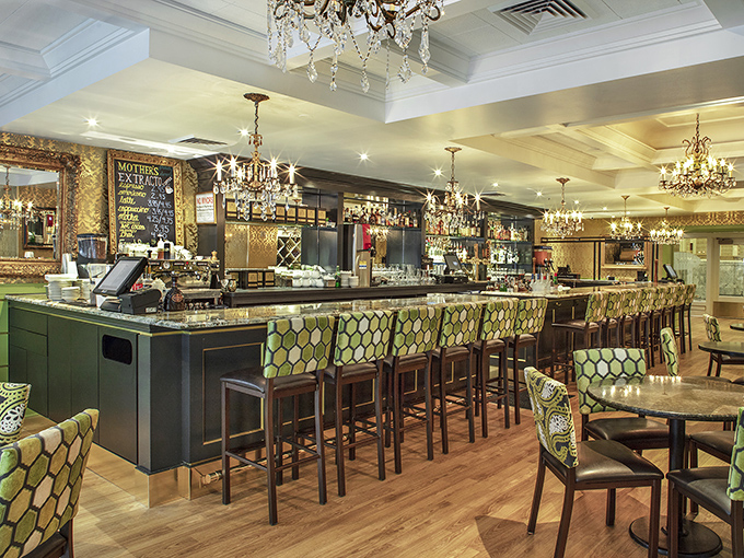 The bar area whispers "stay awhile" with its gleaming countertops and chandeliers that make even morning coffee feel like an occasion.