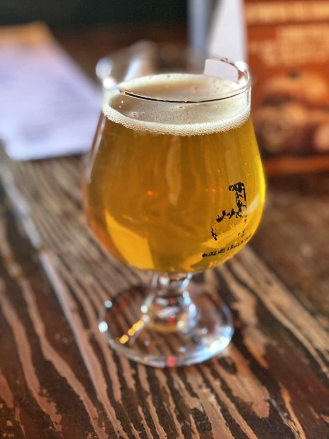 This golden craft beer catches the light like liquid amber. Not just a beverage, but a worthy companion to burger excellence.