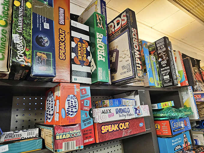 Board games stacked like time capsules of family game nights past – each box containing not just cardboard pieces but potential memories.