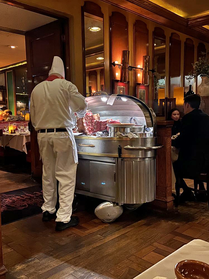 The silver cart ceremony: a server in pristine whites performs the sacred tableside ritual of carving that's equal parts dinner and theater.