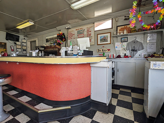 That curved red counter has heard more Virginia stories than a courthouse bench. Every barbecue joint needs a proper stage.