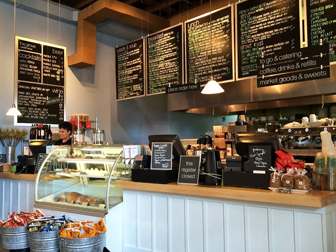 At the counter, pastries tempt from behind glass while chalkboard menus promise delights that make standing in line feel like the prelude to something wonderful.