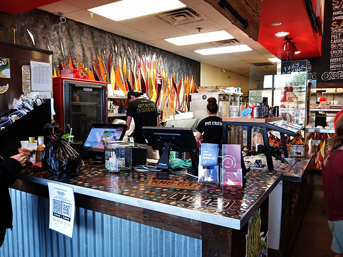 The command center where BBQ dreams become reality. Those staff shirts should read "Happiness Distribution Specialists."