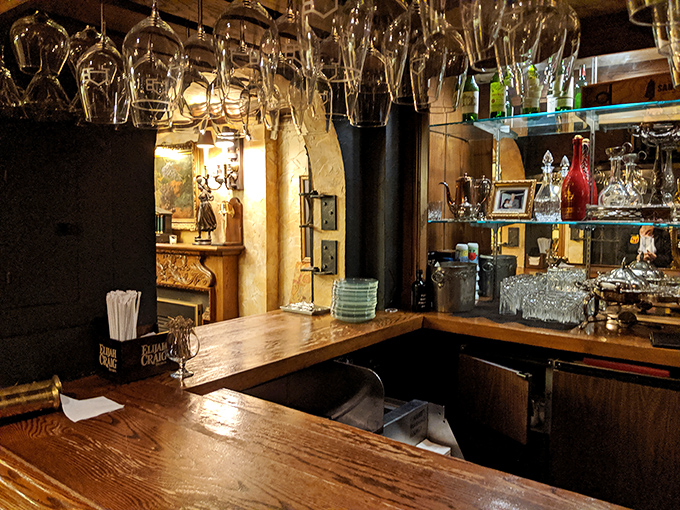 A bar setup that whispers, "Stay awhile." Those upside-down glasses are just waiting for stories to be poured beneath them.