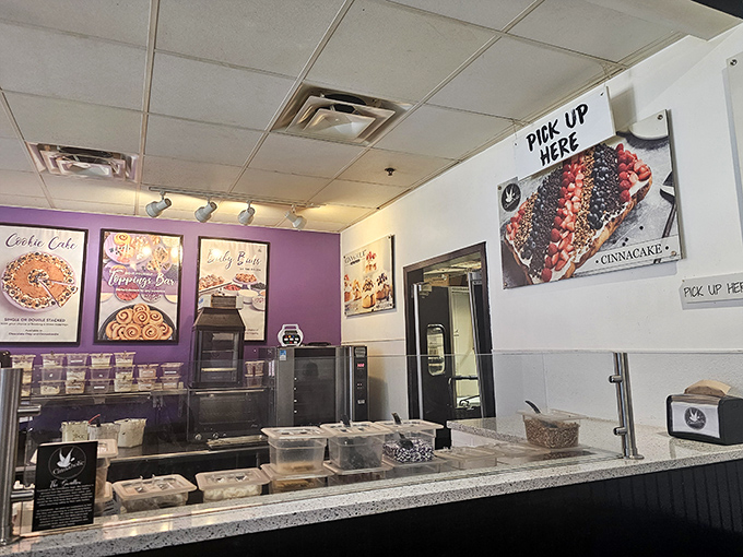Purple walls frame the gateway to temptation. The pickup counter&mdash;where dreams materialize into take-home boxes of joy.
