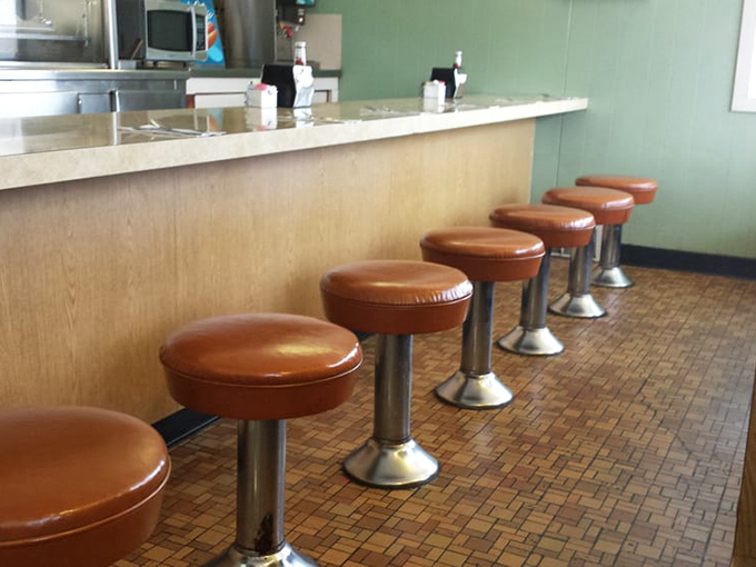 Counter seats aren't just seating—they're front-row tickets to the burger ballet, where spatulas move with the grace of conductor's batons.