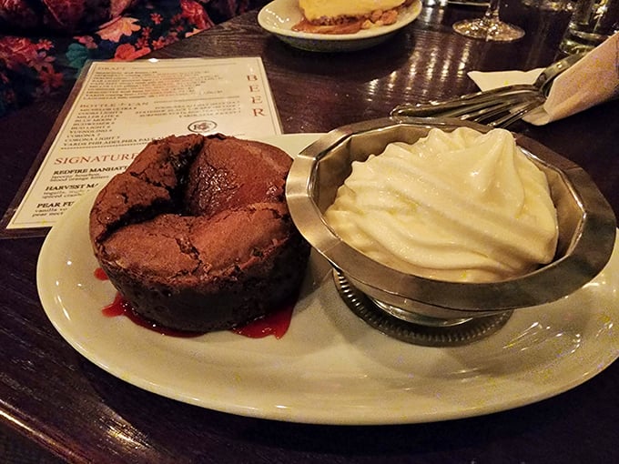 A chocolate dessert that collapses under your spoon, revealing a molten center that would make even the most disciplined diner abandon restraint.