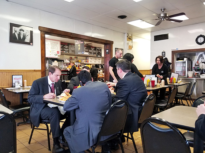 Business suits and serious expressions—these gentlemen understand that eating at Slyman's requires focus, dedication, and possibly a post-lunch nap.