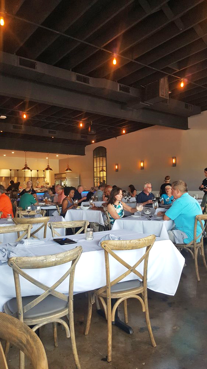 The dining room hums with the symphony of good decisions. Those cross-back chairs aren't just seating&mdash;they're front-row tickets to the best meal in town.