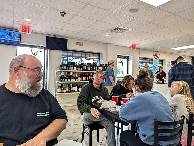 The true measure of a great eatery: real people enjoying real food without pretense. Notice the lack of phones &ndash; the food demands full attention.