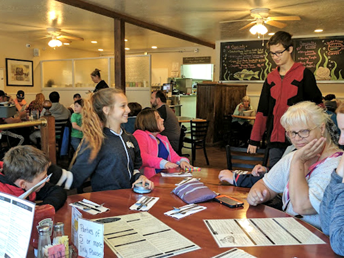 Where locals and tourists unite in the universal language of "mmm." That chalkboard menu in the background holds the secrets to happiness.
