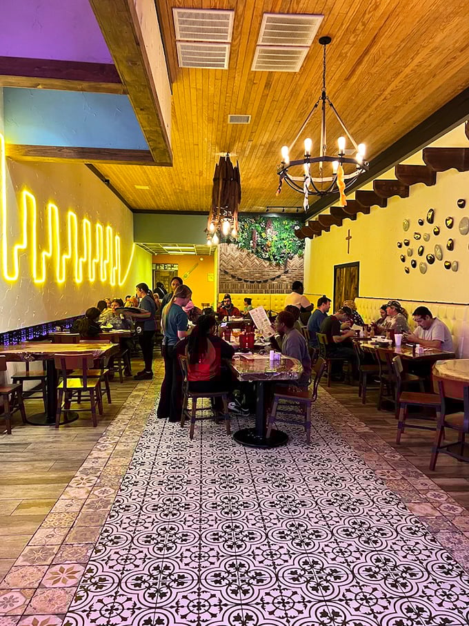 The neon glow creates the perfect backdrop for diners enjoying that magical moment when conversation and cuisine become one.