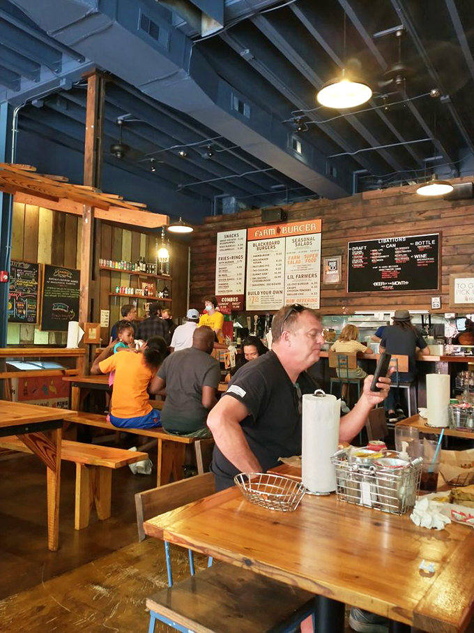 The bustling interior is where burger dreams come true. That exposed ceiling says "industrial chic," but the food says "come home."