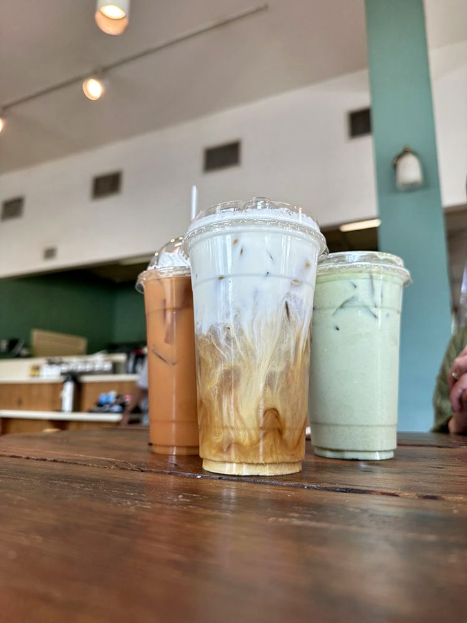 Coffee artistry in its natural habitat &ndash; where milk and espresso perform their swirling dance of caffeinated perfection against wooden backdrops.