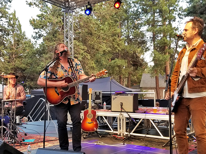The Sisters Folk Festival transforms pine-scented air into the perfect acoustic backdrop, where flannel shirts are both fashion statement and practical choice.