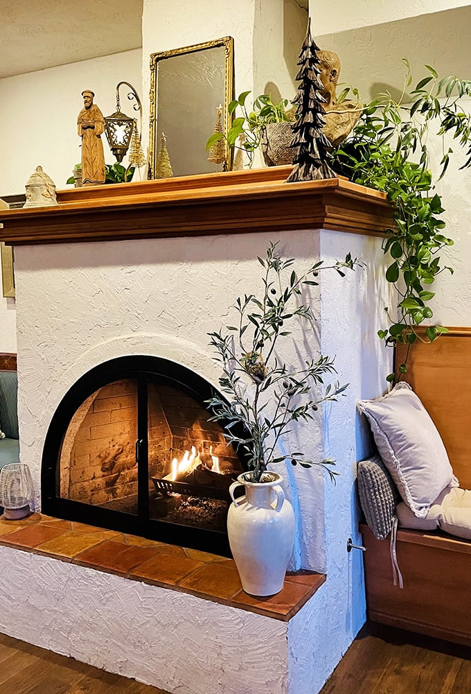 A crackling fire behind glass doors proves that even castle-dwellers appreciate the simple pleasure of flames on a foggy coastal evening.