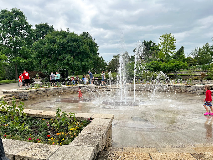 Children splash in the fountain plaza, discovering that the best garden irrigation system is sometimes pure, unbridled joy.
