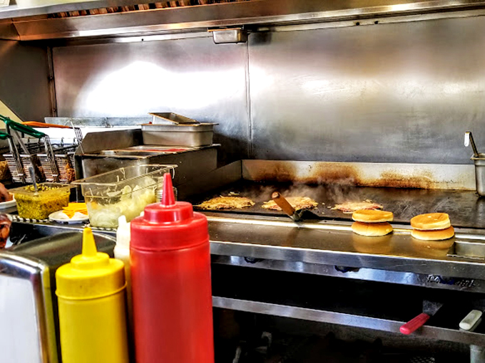 The flat-top grill&mdash;hallowed ground where onion burger magic happens. Those spatulas might as well be wands in the hands of culinary wizards.