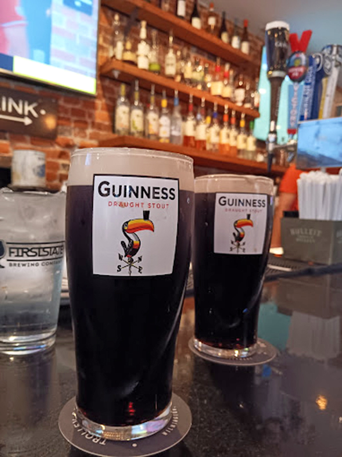 Guinness glasses stand like sentinels of good taste. The perfect dark companion to briny oysters—a pairing older than most relationships.