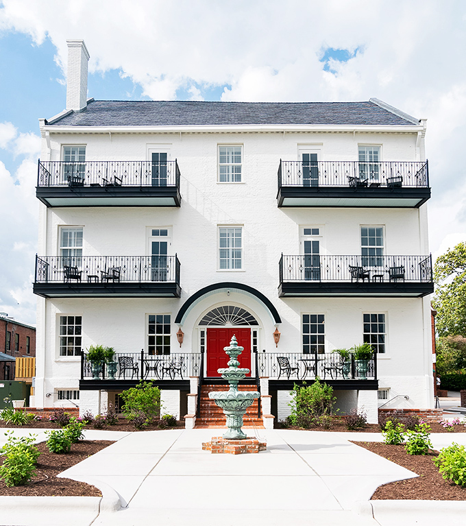 Beautiful white colonial-style inns with distinctive red doors offer elegant accommodations where history meets modern comfort.