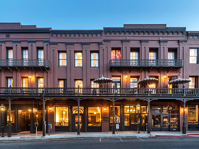 The historic hotel glows at dusk, its windows illuminated like a Victorian-era Instagram filter applied to real life.