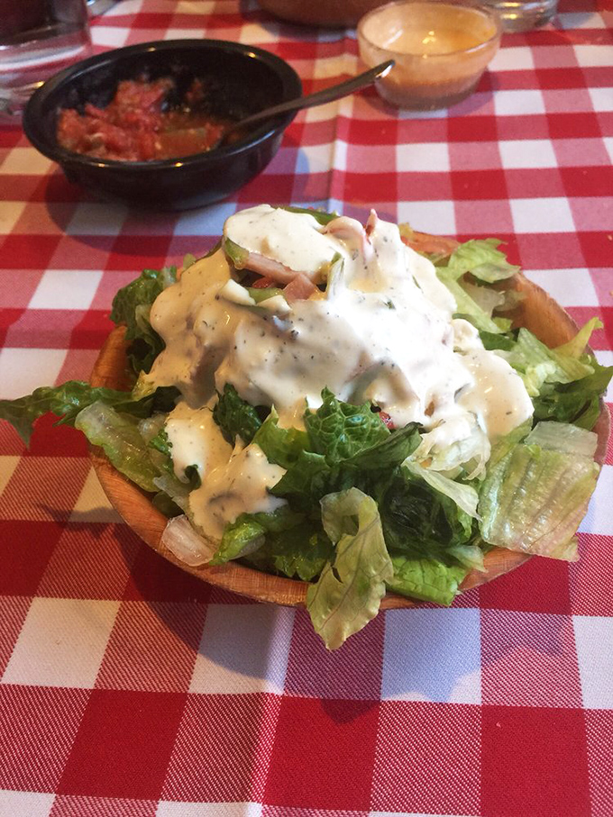 The house salad provides the illusion of dietary virtue before your massive steak arrives, like wearing workout clothes to the mall but never entering the gym.