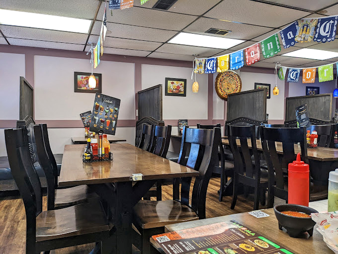 Simple tables, colorful papel picado banners overhead &ndash; this dining room doesn't need fancy d&eacute;cor when the food is the real conversation starter.