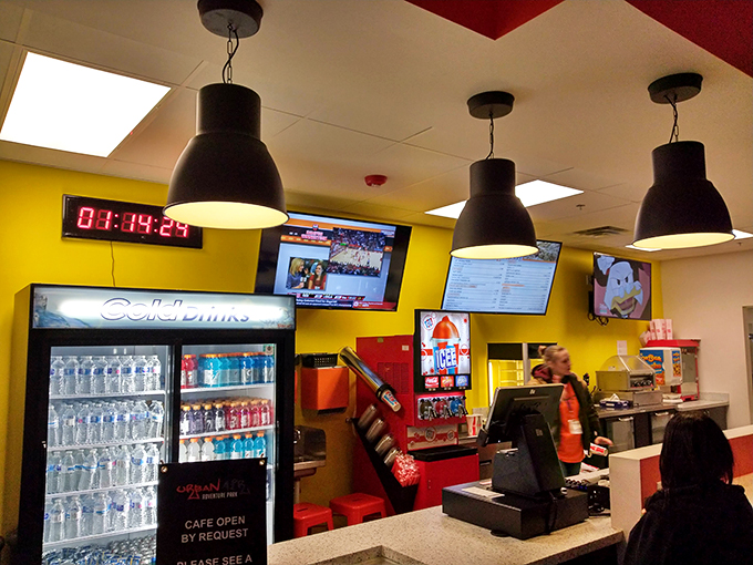 The caf&eacute;'s bright yellow walls and cold drink selection stand ready to rehydrate warriors returning from trampoline battles.